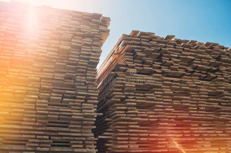 A Large Stack of Lumber Boards is Neatly Stacked at a Lumber Yard. the ...