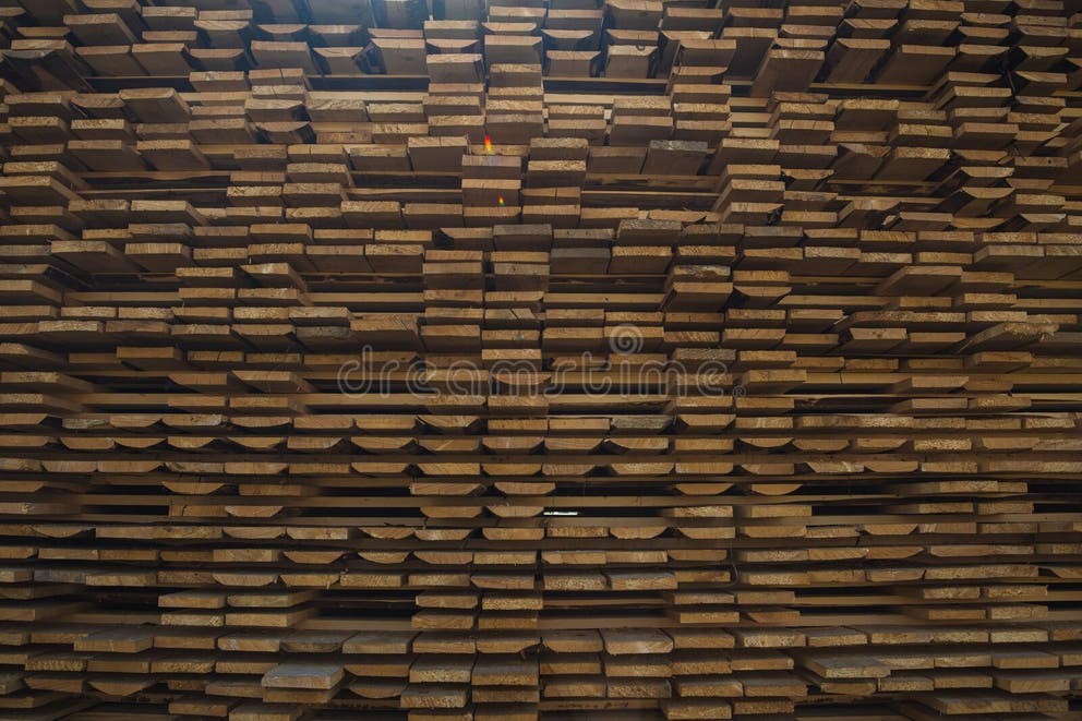 A Large Stack of Lumber Boards is Neatly Stacked at a Lumber Yard. the ...