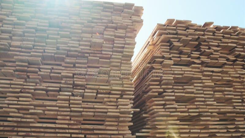A Large Stack of Lumber Boards is Neatly Stacked at a Lumber Yard. the ...