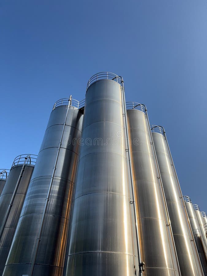 Large Stack of Metal Tanks with a Clear Blue Sky in the Background ...