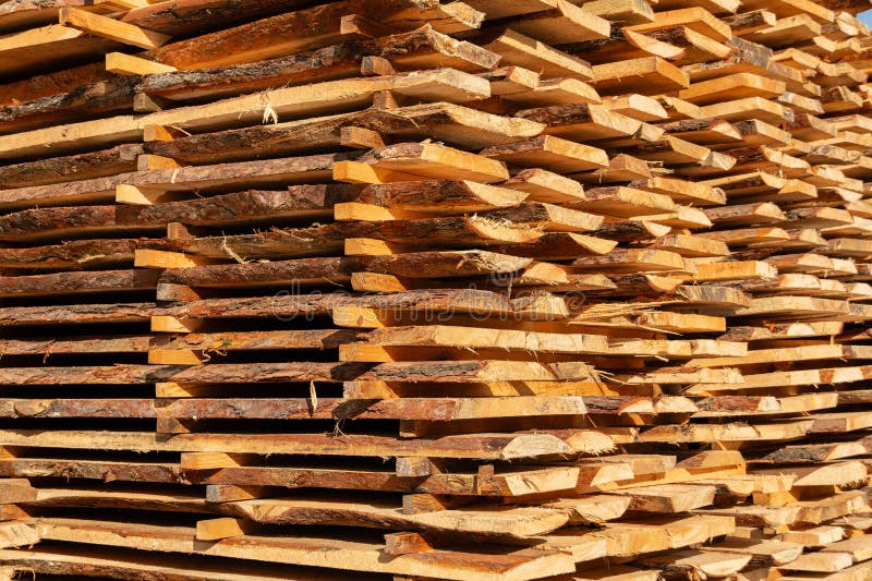 A Large Stack of Wooden Planks Rests in the Sun, Drying at a Lumber ...