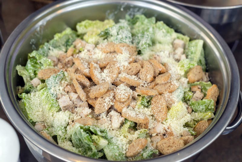 A Large Stainless Bowl of Caesar Salad on a Catering Table Served for ...