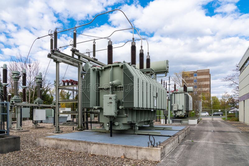 A Large Stationary Electrical Transformer Against a Cloudy Sky. Stock ...