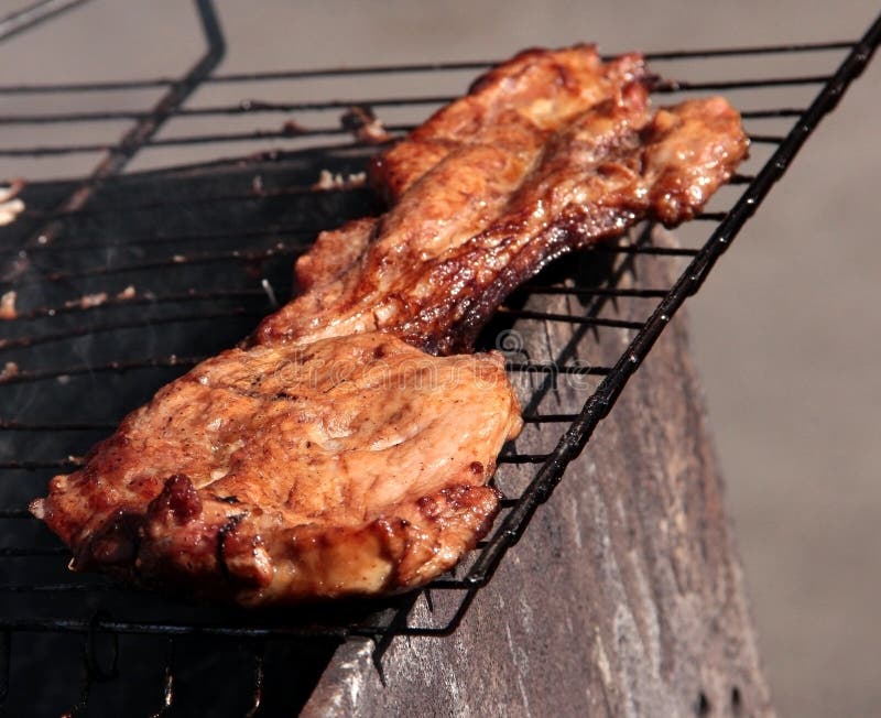 A Large Steak of Grilled Meat with Smoke. Cooking in the Open Air Stock ...