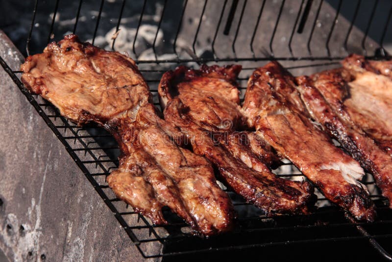 A Large Steak of Grilled Meat with Smoke. Cooking in the Open Air Stock ...
