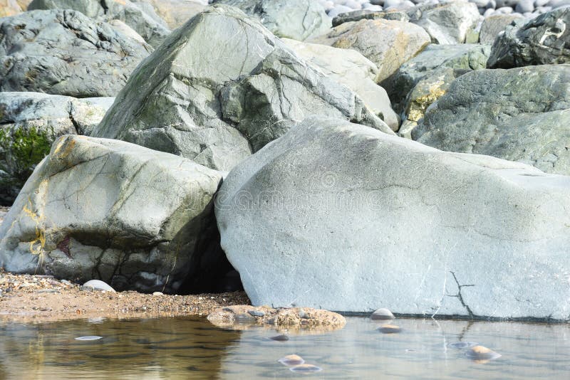 Large Stone Boulder Formation with Reflections in Water Stock Image ...