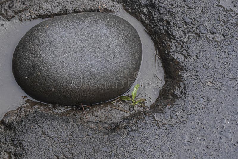 Large Stone in Puddle on Pavement Stock Image - Image of abstract, rain ...