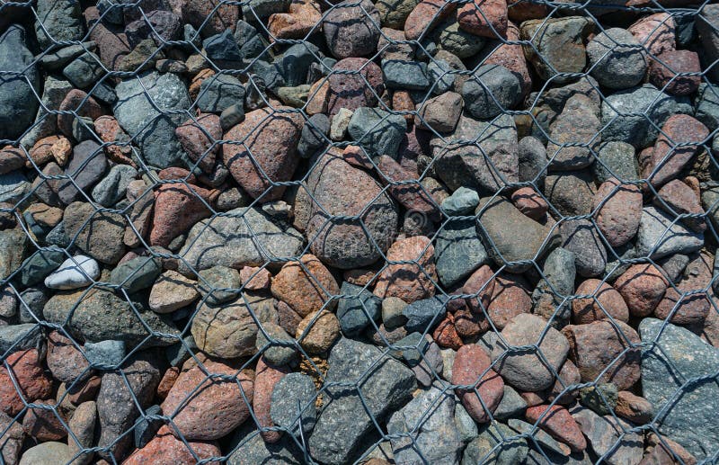 Large stones in wire mesh stock image. Image of wall - 262822147