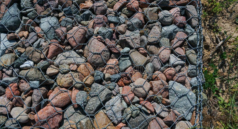 Large stones in wire mesh stock image. Image of pebble - 262822927