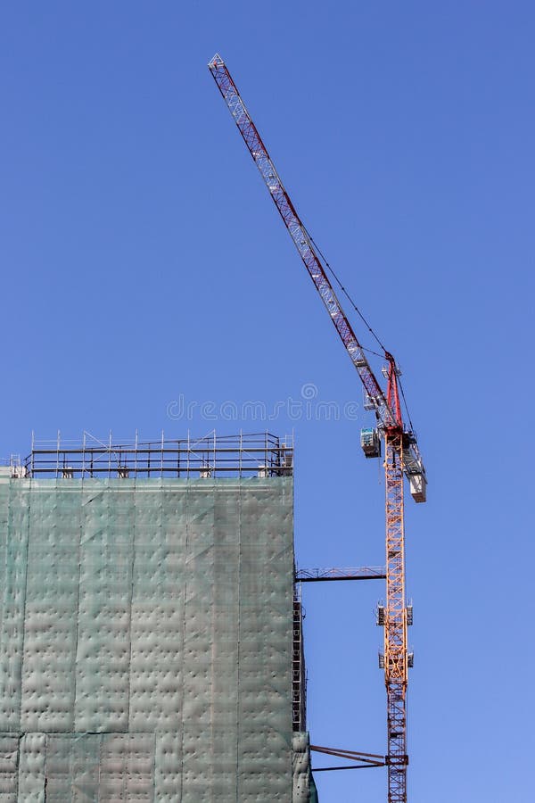 Crane at construction site stock image. Image of large - 156422863
