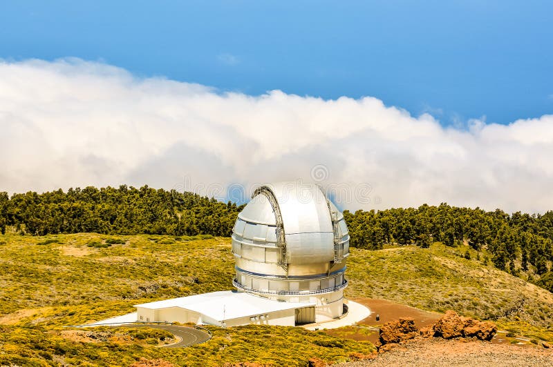 A Large Telescope is on a Hill with a Cloudy Sky in the Background ...