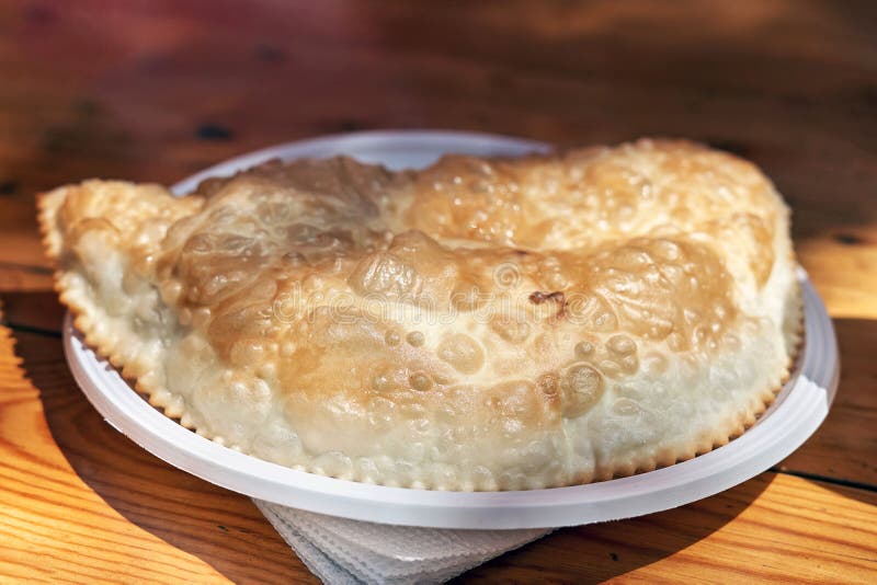 Large Toasted Brown Cheburek on a Disposable Plate Stock Image - Image ...