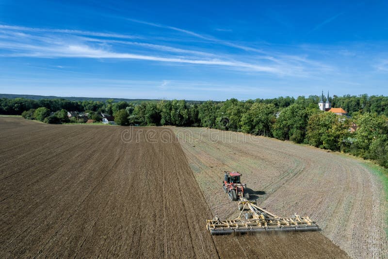 Large Tracked Tractor Mills the Ground in a Field Near the Village ...