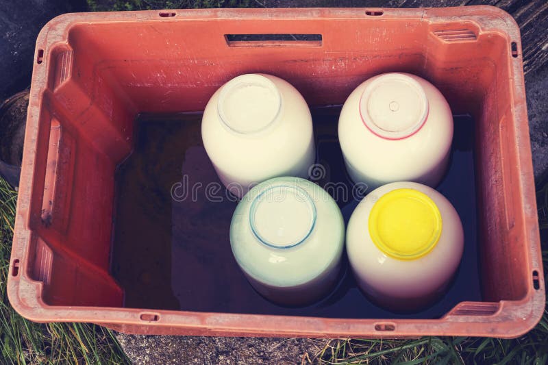A Large Transparent Jar with Milk in it. a Plastic Box Filled with ...