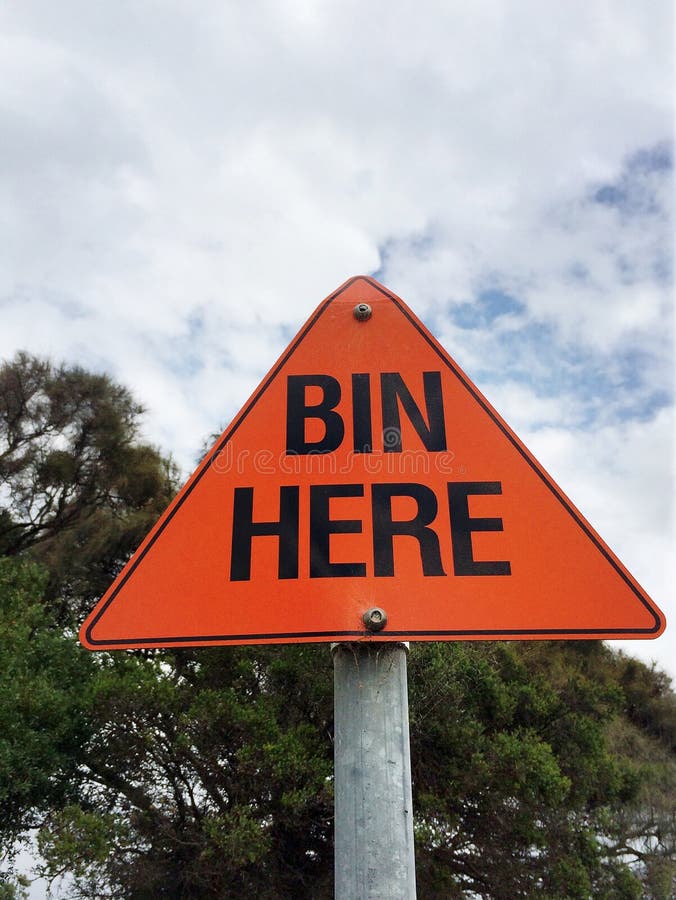 Large Triangular Shaped Sign with Black Text on an Orange Background ...