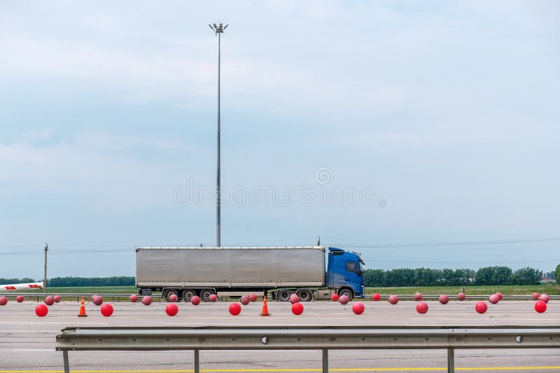 A Large Truck with a Cargo Trailer is Driving Along the Highway. Stock ...