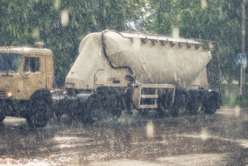Large Truck with a Trailer on the Road Under Heavy Rainfall Stock Photo ...