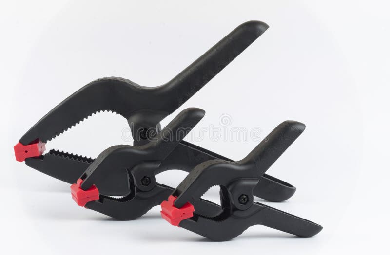 Large and Two Small Plastic Clamps on a White Background Stock Image ...