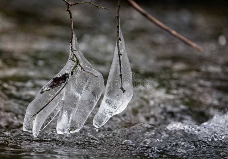 Large and Unusual Ice Formations Dangling Above Raging Water Stock ...