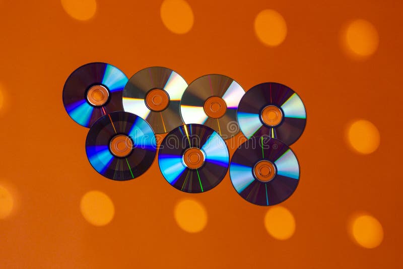Large Variety of Arranged CD Disks or DVD Disks on Orange Background ...