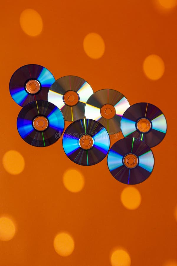 Large Variety of Arranged CD Disks or DVD Disks on Orange Background ...