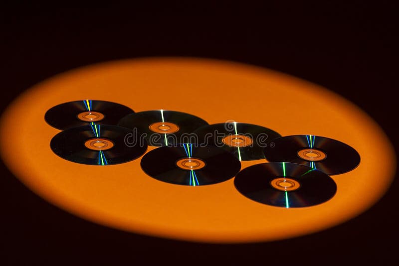 Large Variety of Arranged CD Disks or DVD Disks on Orange Background ...