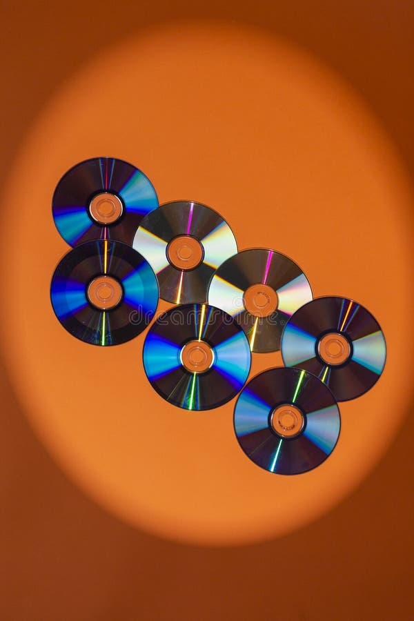 Large Variety of Arranged CD Disks or DVD Disks on Orange Background ...
