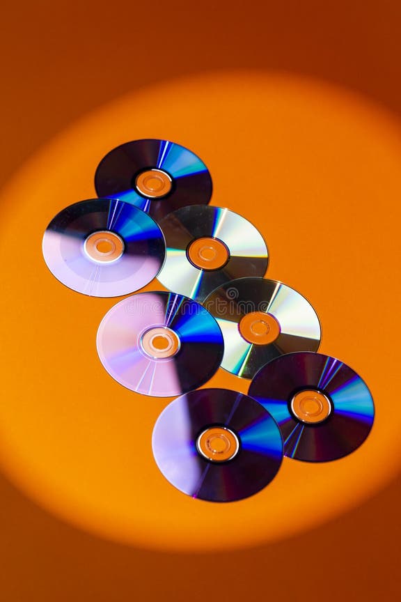 Large Variety of Arranged CD Disks or DVD Disks on Orange Background ...