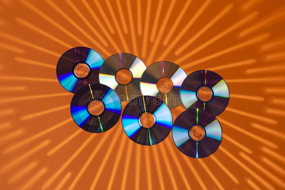 Large Variety of Arranged CD Disks or DVD Disks on Orange Background ...