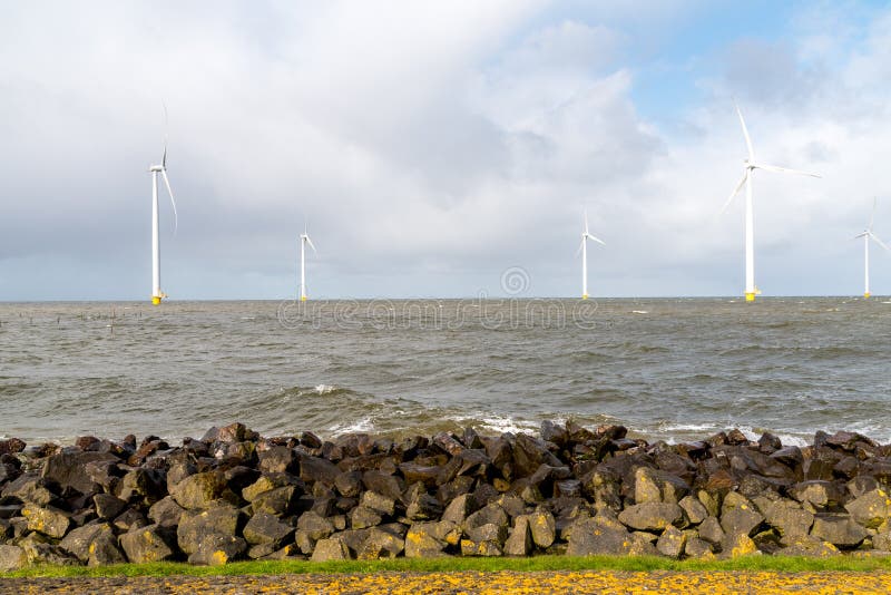 Windmills in the ocean stock photo. Image of mega, blades - 99337096