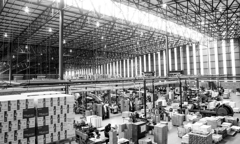 A Large Warehouse with Several Shelves, Boxes and Tables in it ...