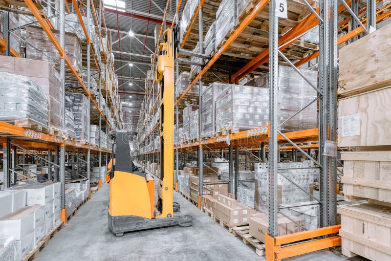 Large Warehouse. Tall and Long Metal Racks Filled with Various Boxes ...