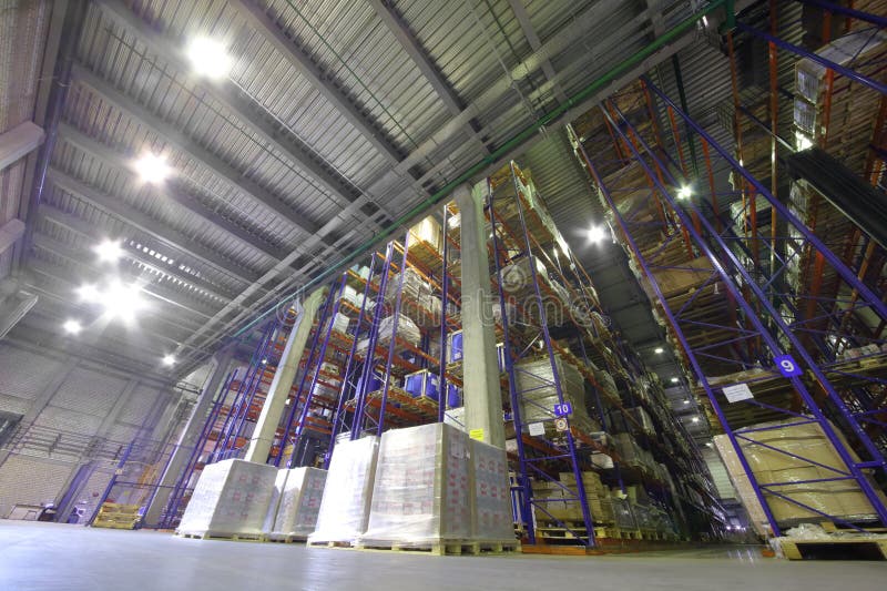 A Large Warehouse with Many Boxes Stacked on Shelves Stock Image ...
