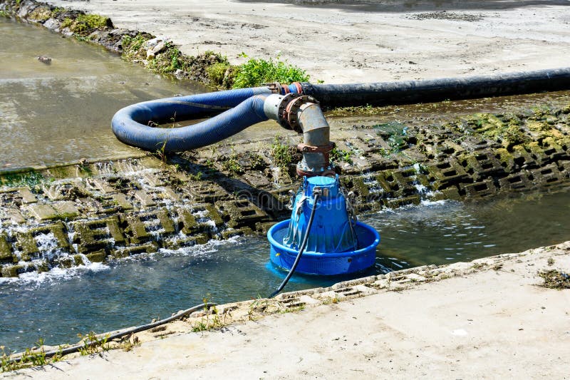 Large Water Pump and Hose System Working in a Concrete Drainage Channel ...