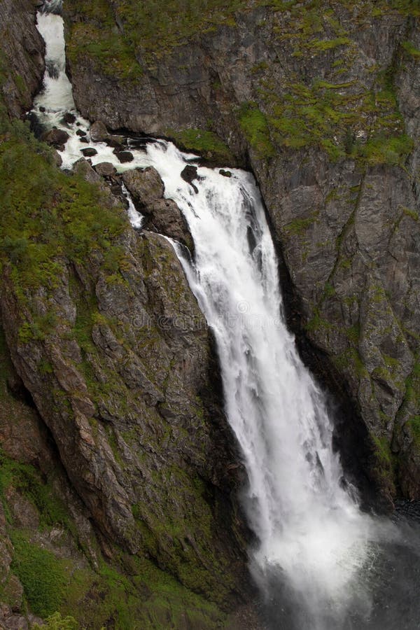 Large Waterfall Flowing Over a Lush Green Hillside Stock Photo - Image ...