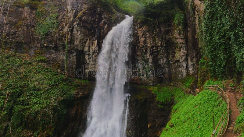 A Large Waterfall Flows from the Cliff. Landmark of Abkhazia Stock ...