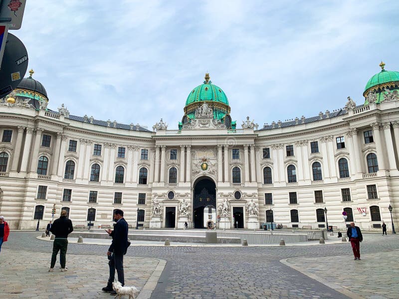 A Large White Building with a Green Dome Sits in Front of a Cloudy Sky ...