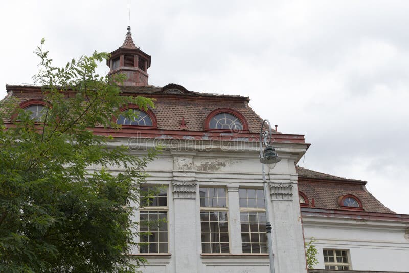 A Large White Building with a Red Roof is Surrounded by Trees Stock ...