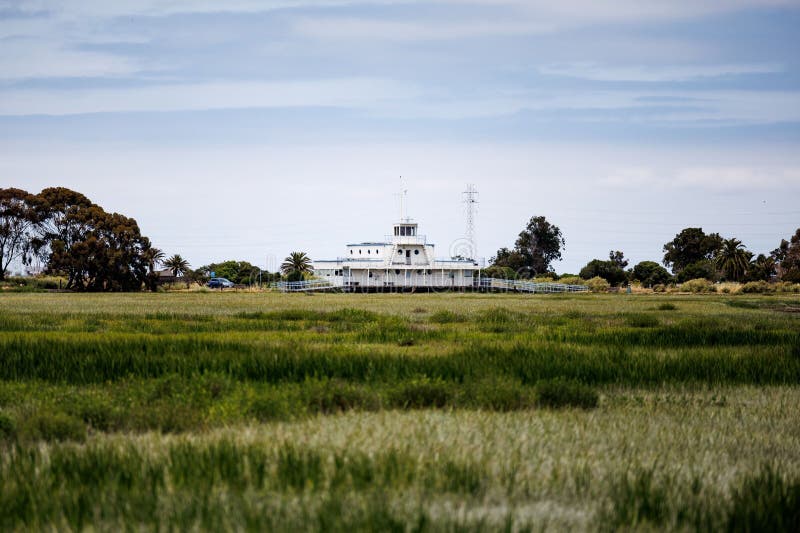 Large White Building Situated on a Grassy Plain at the Coast ...