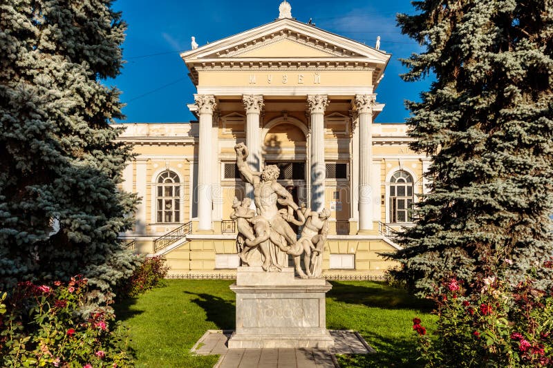 A Large White Building with Statues of Dogs and a Man on Top of it ...