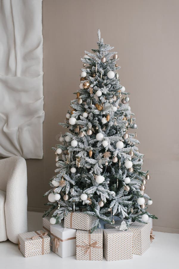 Large White Christmas Tree with Gold and Ornaments in Front of Couch ...