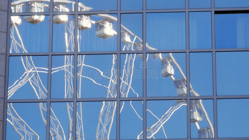 Large White Ferris Wheel Reflected in the Transparent Windows of Modern ...
