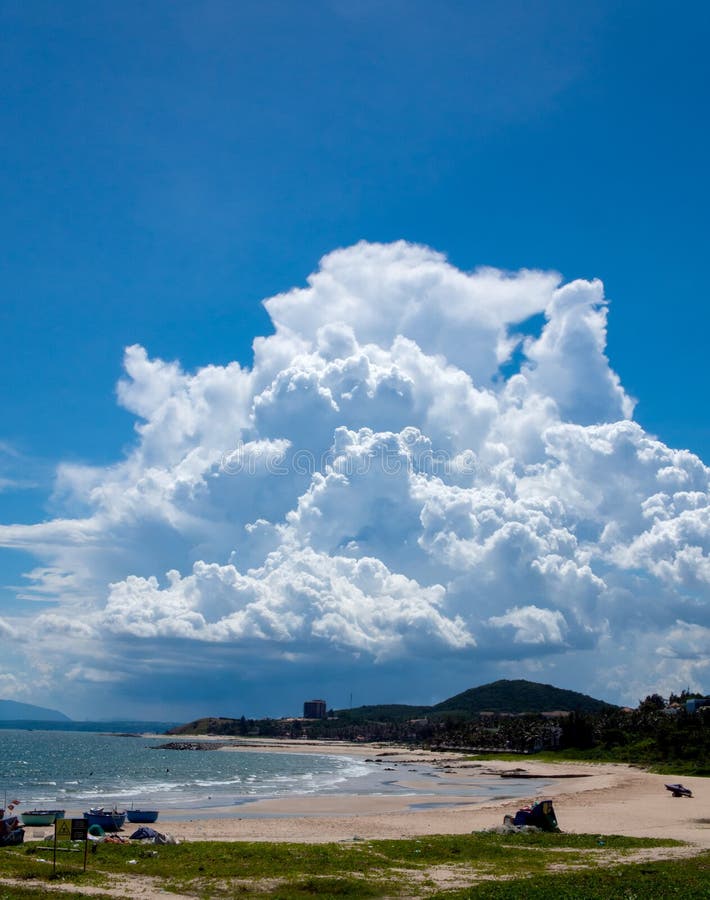 A Large White High Cloud on a Bright Blue Sky Over the Sea and Sandy ...