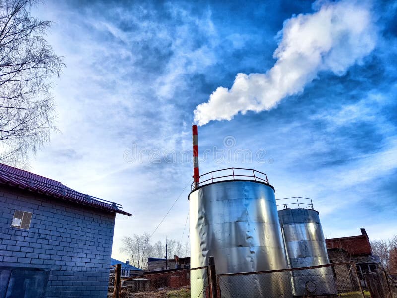 A Large White Plume of Smoke Billows from a Chimney into a Blue Sky ...