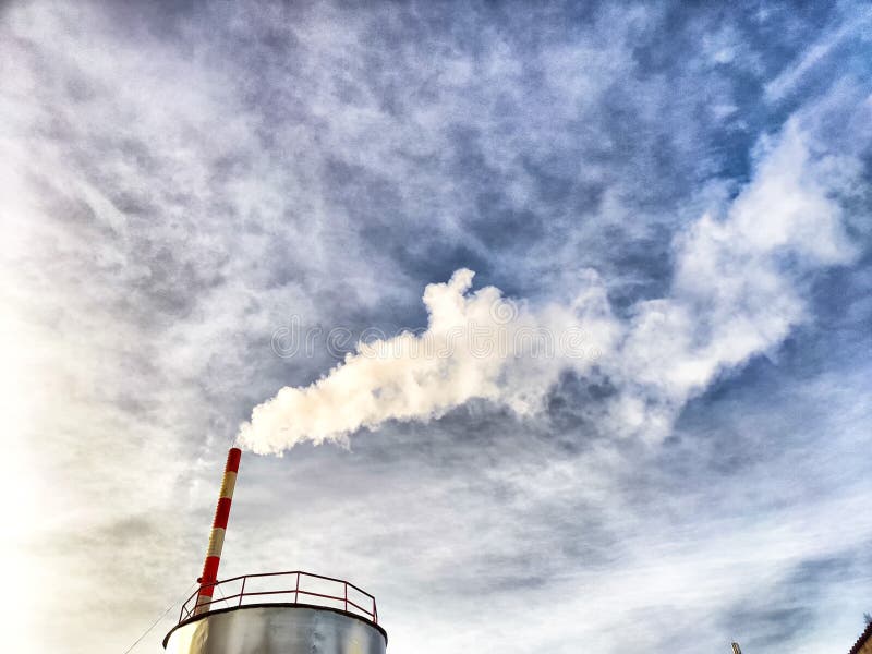 A Large White Plume of Smoke Billows from a Chimney into a Blue Sky ...