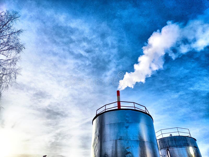 A Large White Plume of Smoke Billows from a Chimney into a Blue Sky ...