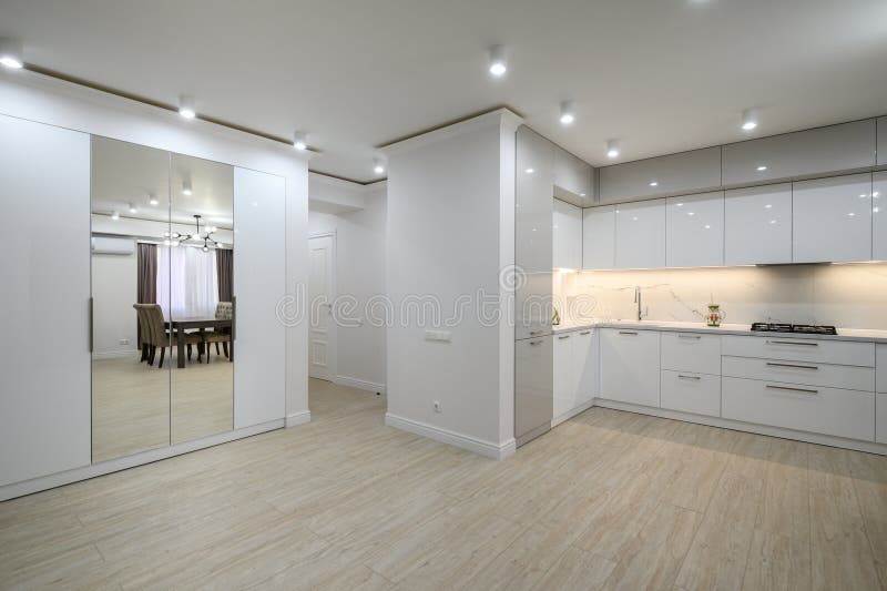 Large White Room Connected To Hall and Kitchen in a Studio Flat Stock ...