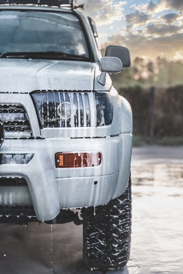 Large White SUV Car in Foam at a Self-service Car Wash, Vertical Stock ...