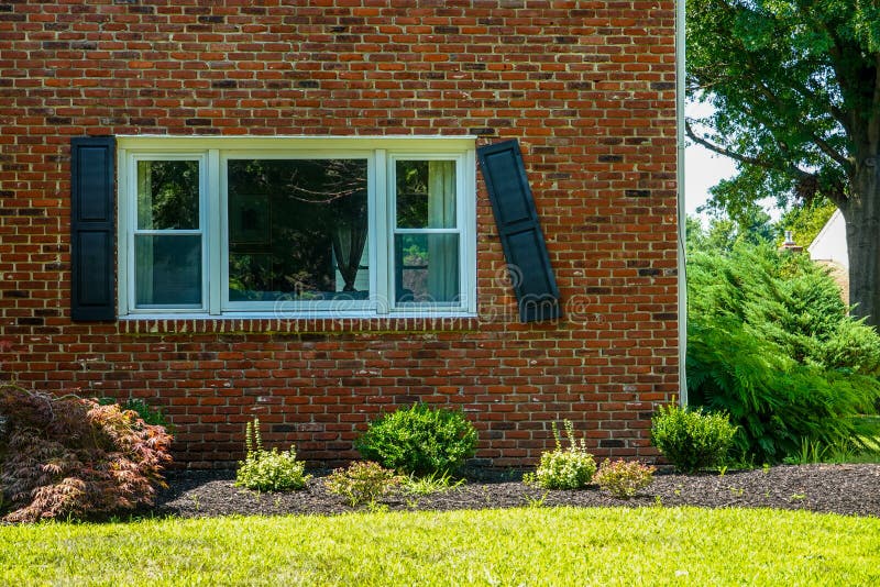 Large Window on the Brick Front Wall of a House with a Black Shutter ...