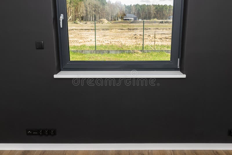 A Large Window in a Room with Black Walls and Fully Open Roller ...